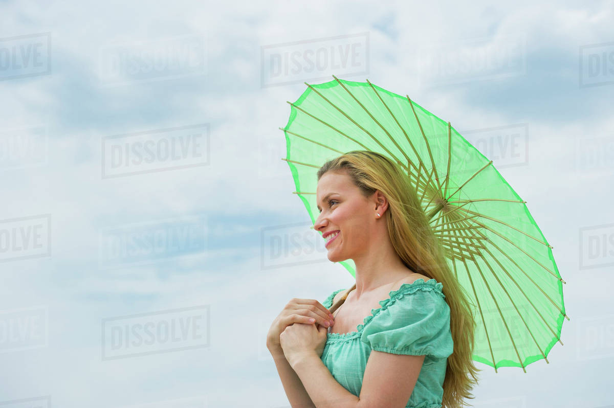 Woman holding parasol - Royalty-free Stock Photo | Dissolve