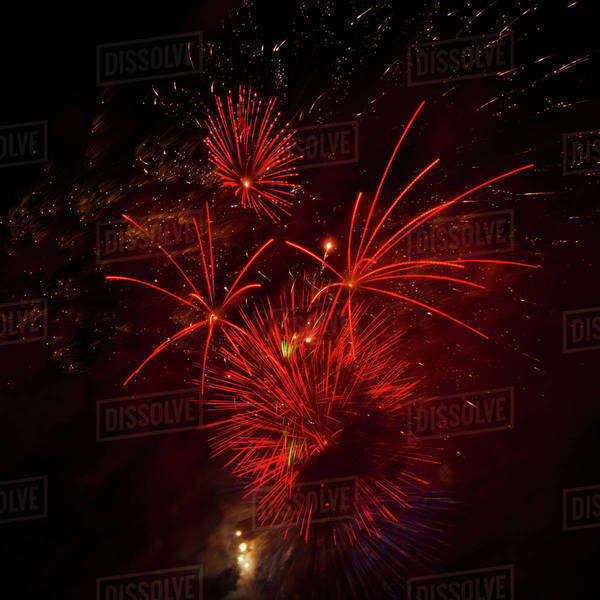 Fireworks explosion against night sky - Royalty-free Stock Photo | Dissolve