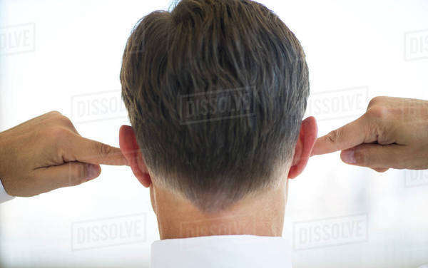 Businessman plugging ears - Royalty-free Stock Photo | Dissolve