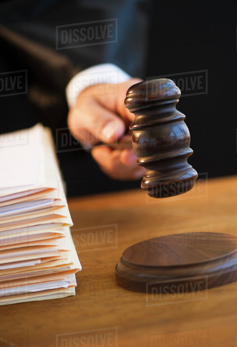 Judge holding gavel, close-up - Royalty-free Stock Photo | Dissolve