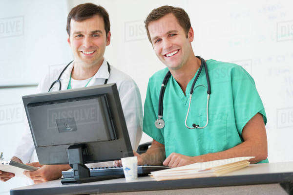 Portrait of two doctors using computer - Royalty-free Stock Photo ...
