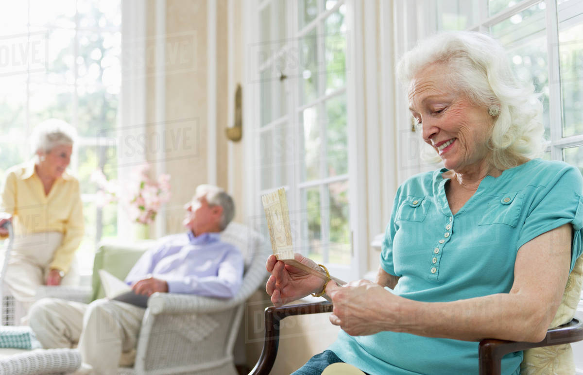 Senior woman reading greeting card - Royalty-free Stock Photo | Dissolve