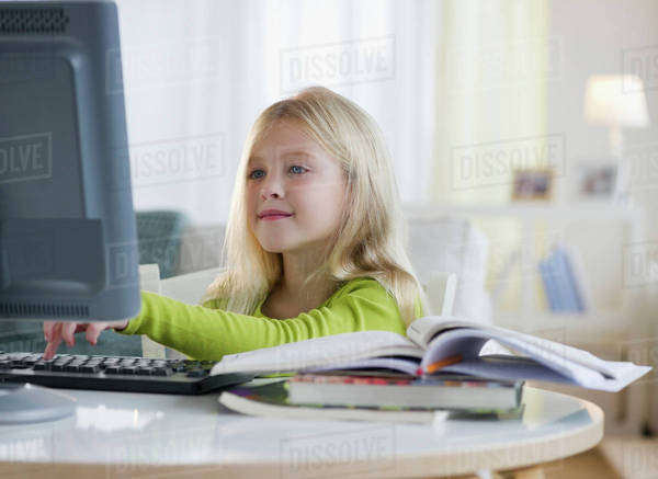 USA, New Jersey, Jersey City, Girl (8-9) sitting in front of computer ...