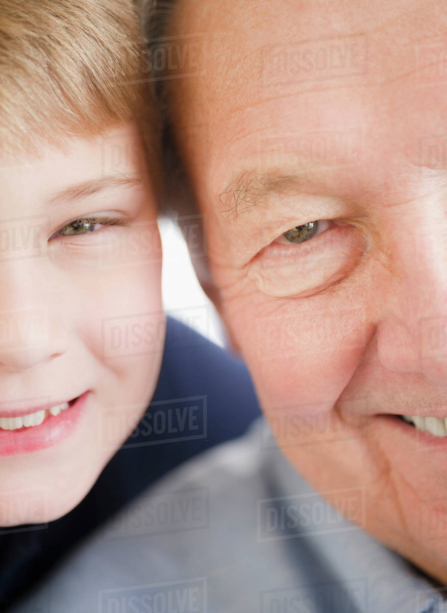 Close up of smiling faces of grandfather and grandson (8-9) - Royalty ...