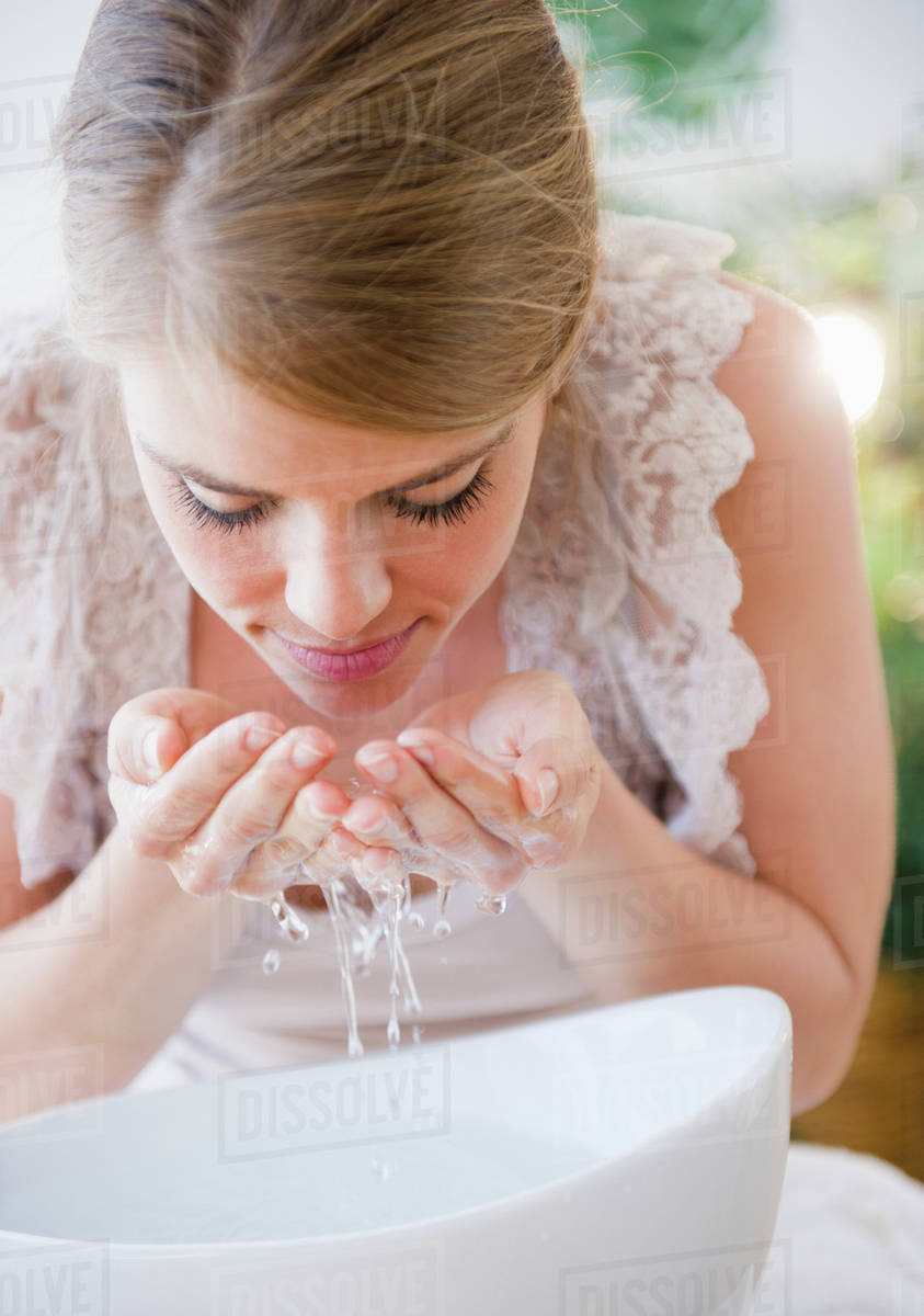 Woman washing face with water - Royalty-free Stock Photo | Dissolve