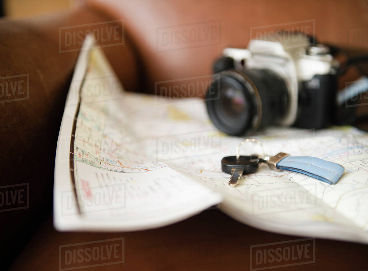 Close up of map, camera and car keys - Stock Photo - Dissolve