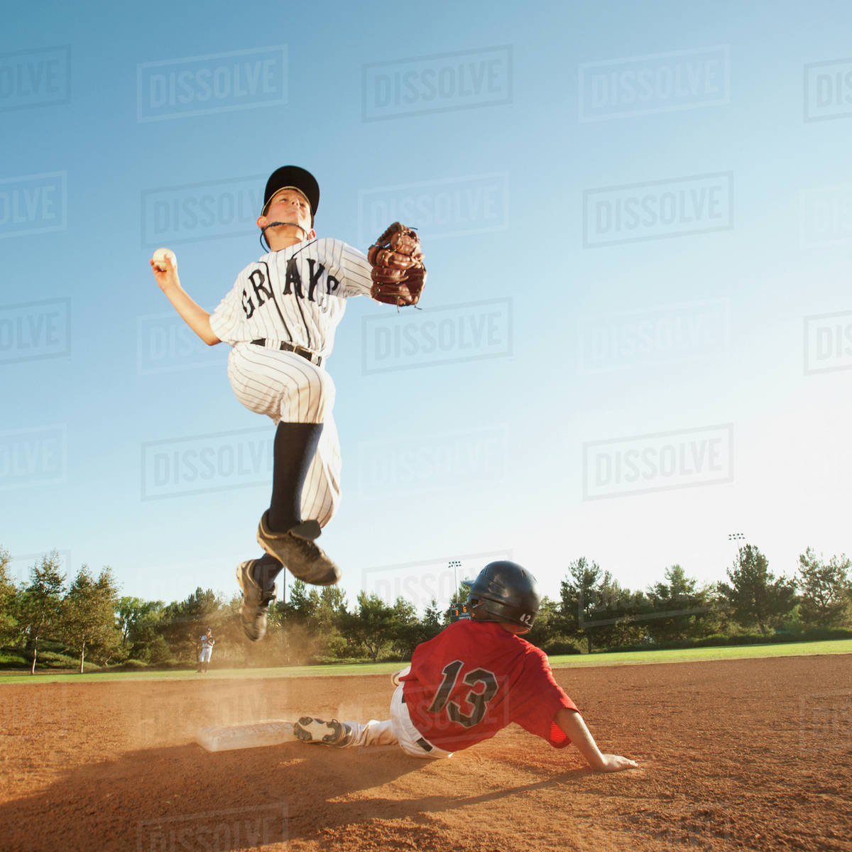 Boys (10-11) playing baseball - Royalty-free Stock Photo | Dissolve