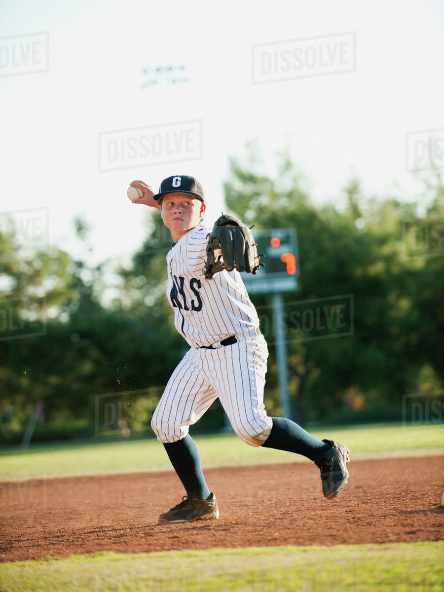 Boy (10-11) playing baseball - Royalty-free Stock Photo | Dissolve