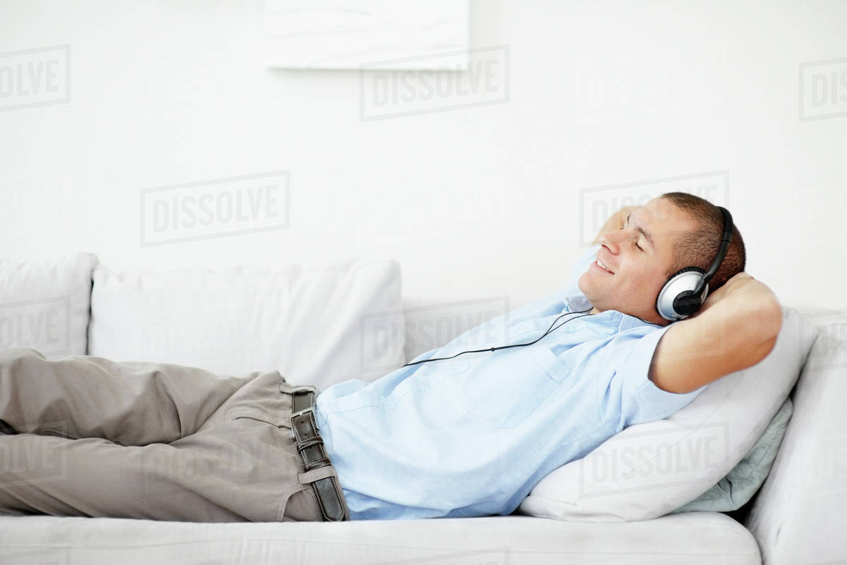South Africa, Man relaxing while listening music - Royalty-free Stock ...