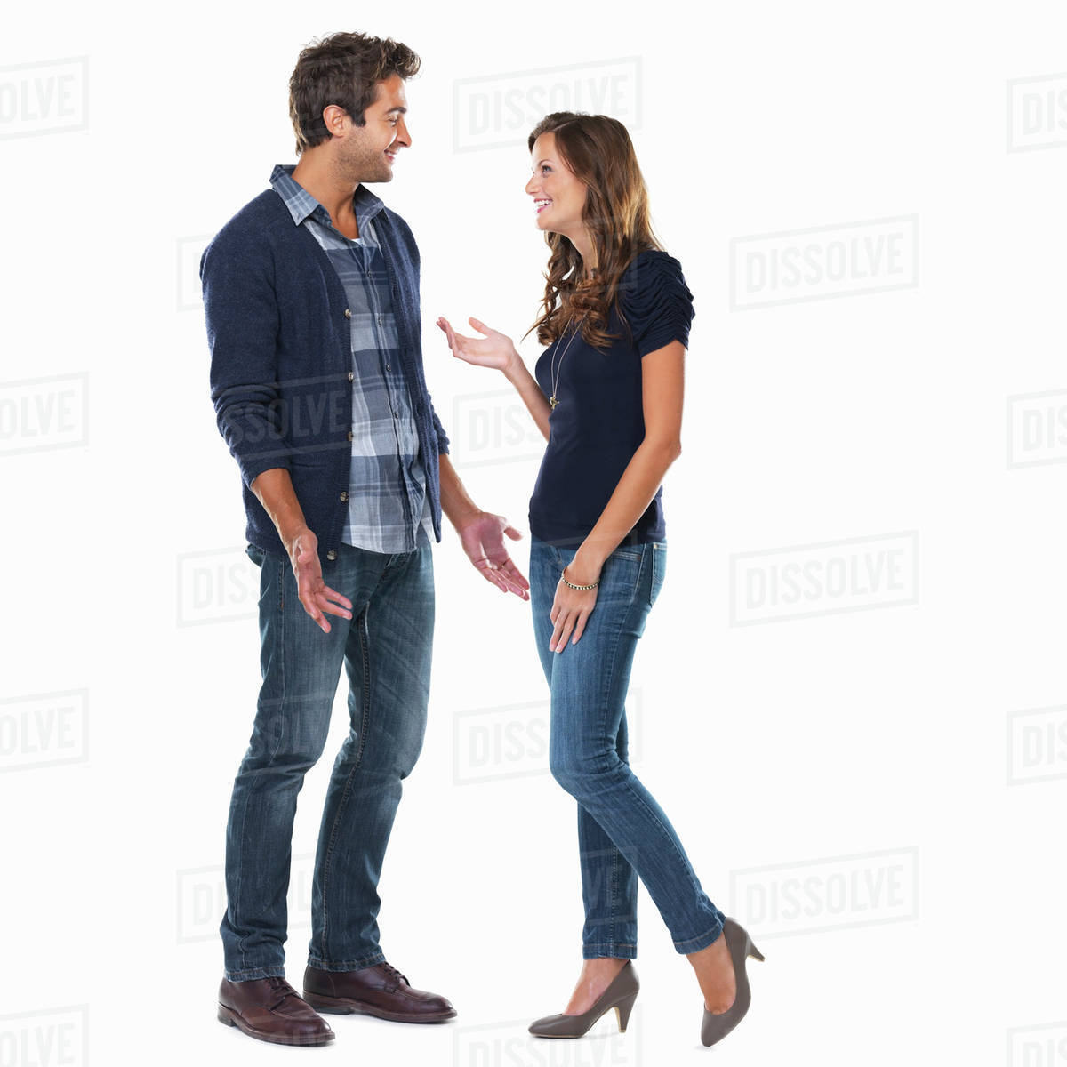 Studio shot of young couple smiling and talking - Stock Photo - Dissolve