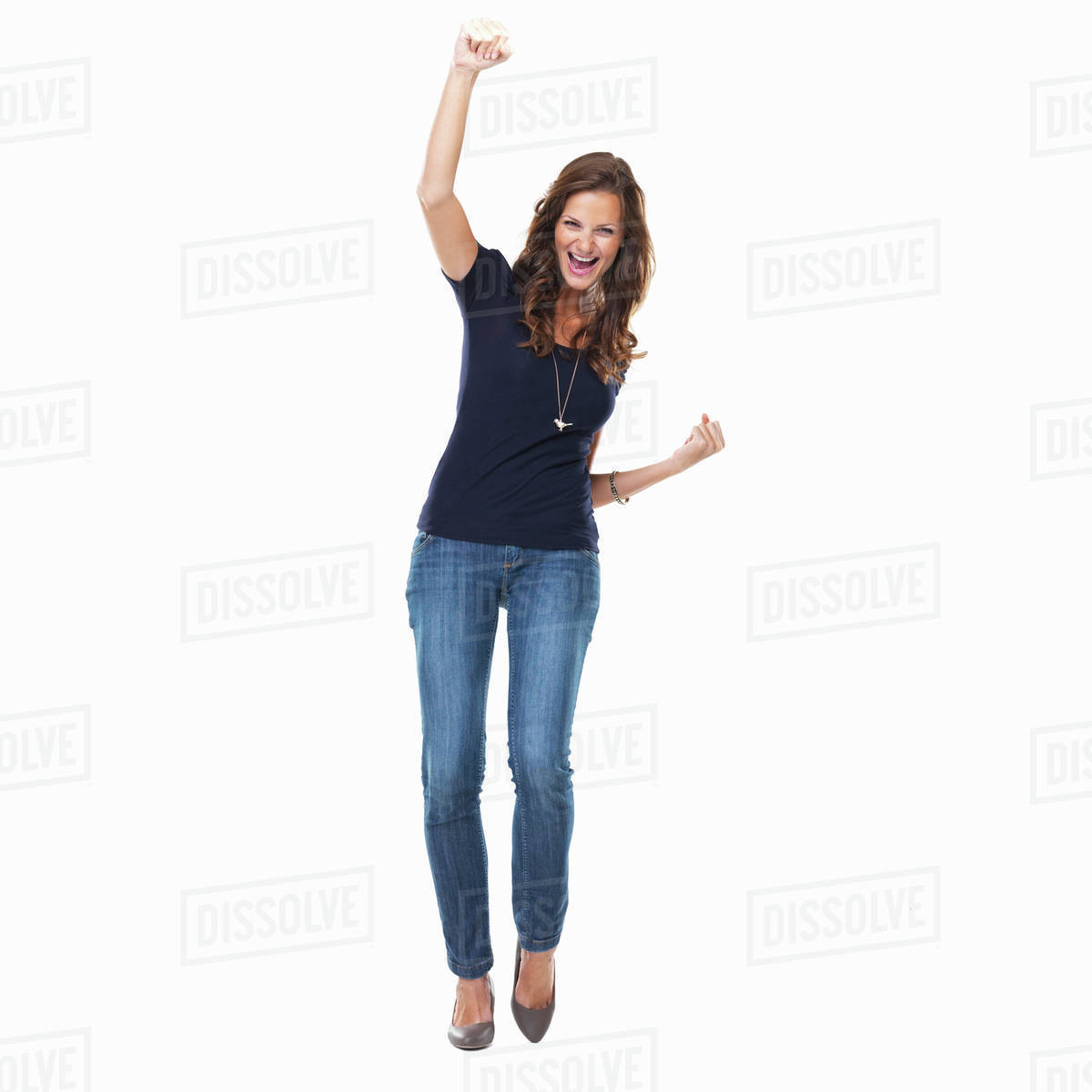 Studio shot of young woman celebrating with arm raised - Royalty-free ...