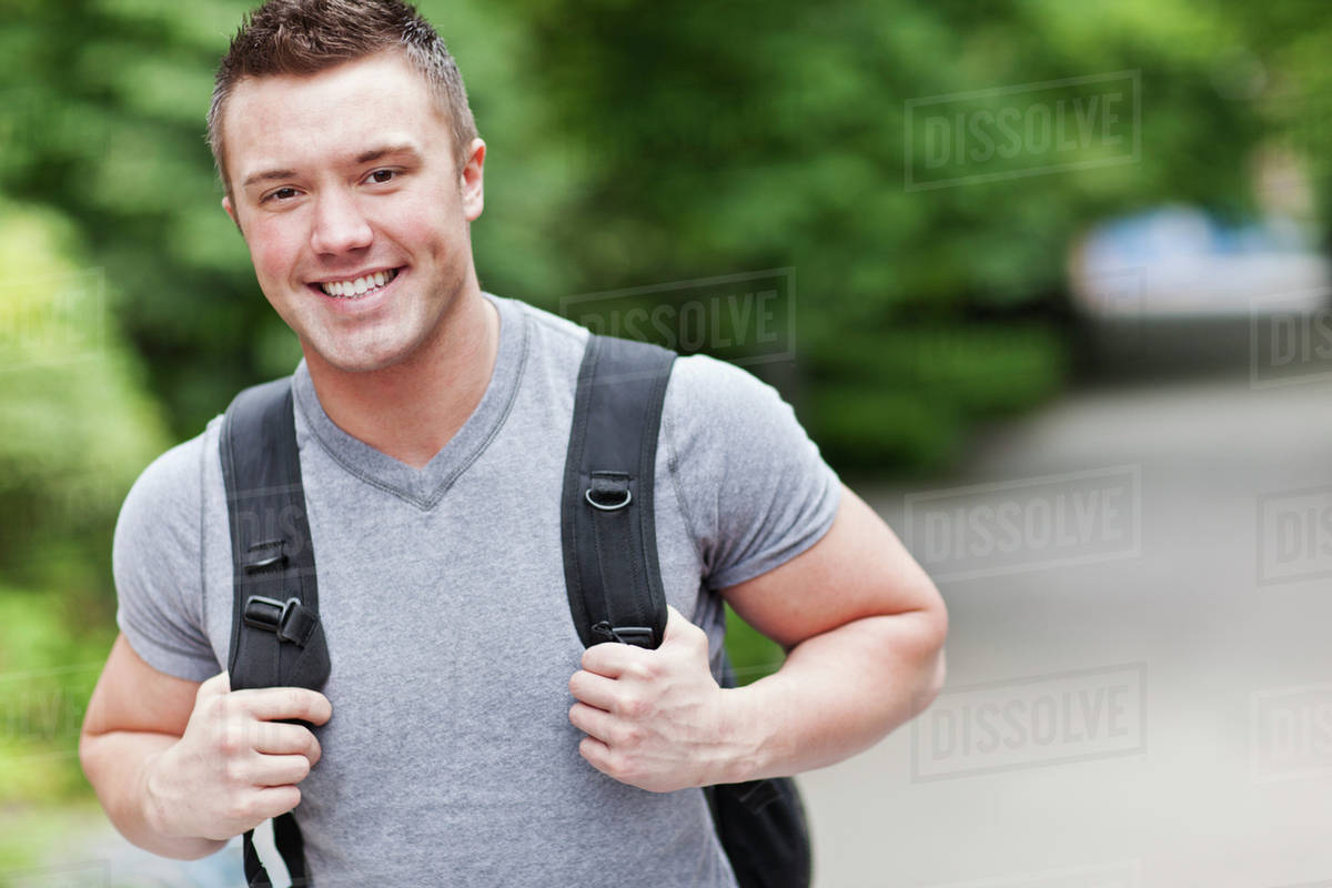 Portrait of male college student smiling - Stock Photo - Dissolve