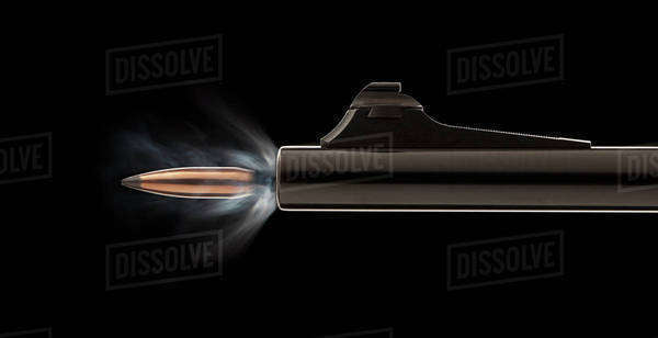 Studio shot of bullet coming out of gun barrel - Royalty-free Stock ...
