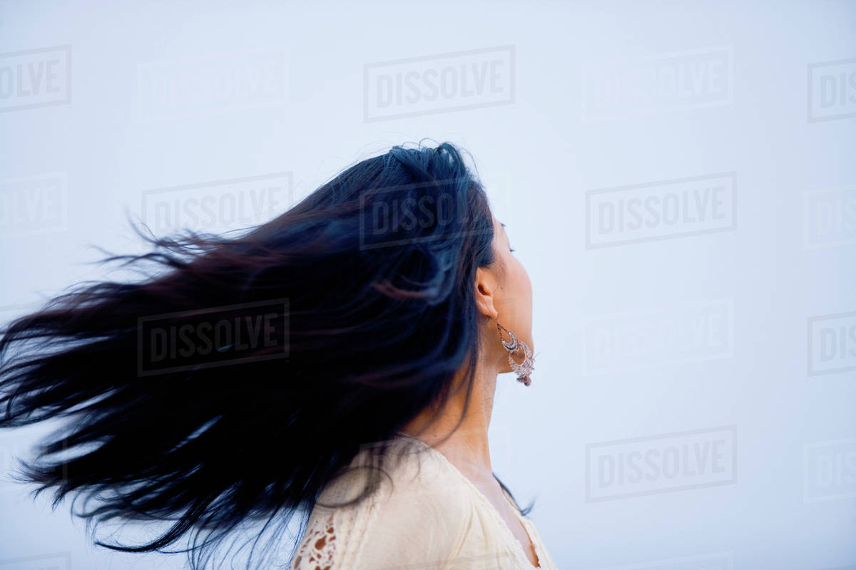 Windswept young woman - Stock Photo - Dissolve