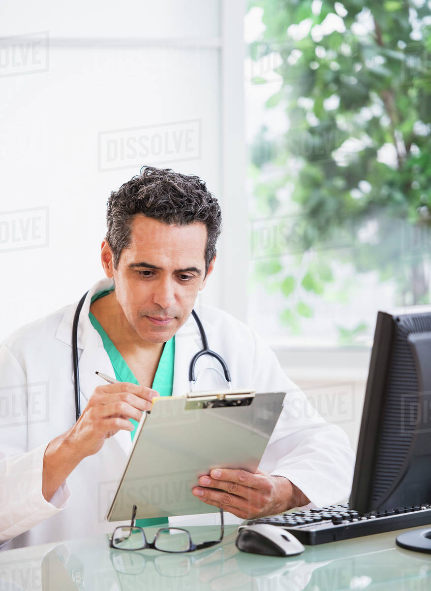 Portrait of doctor working in office - Stock Photo - Dissolve