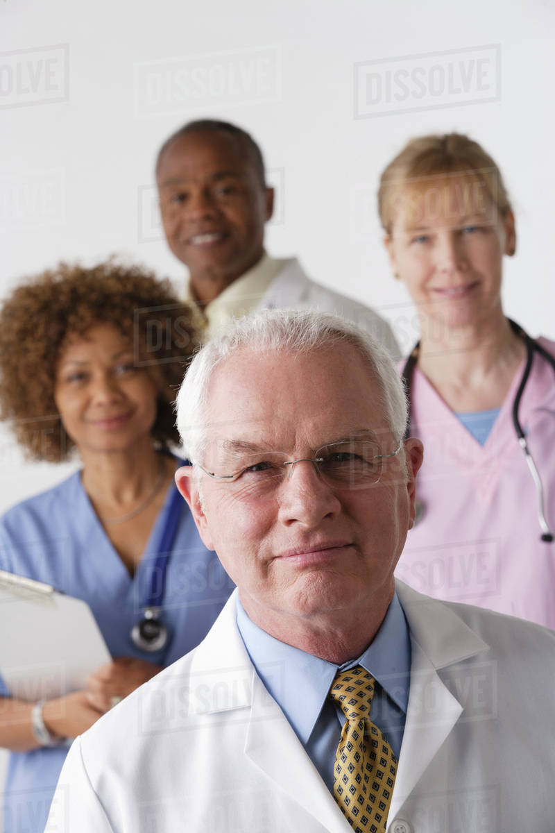 Portrait of four medical professionals, studio shot - Stock Photo ...