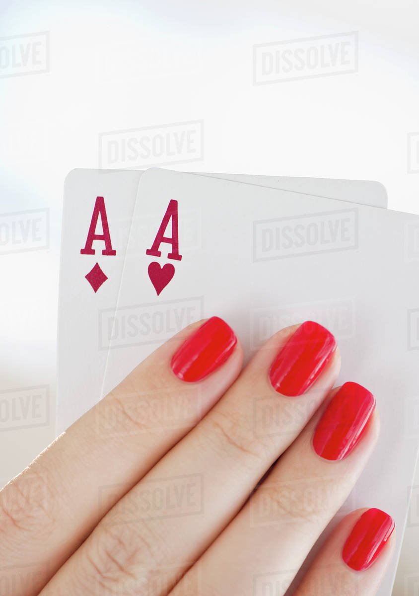 Hand holding a pair of aces - Royalty-free Stock Photo | Dissolve
