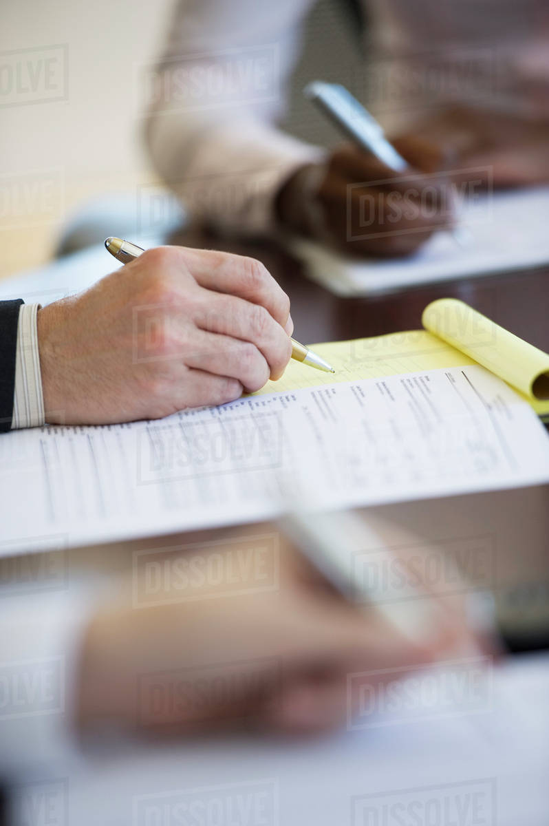 Business people writing notes during business meeting - Royalty-free ...