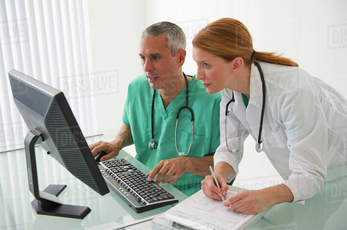 Healthcare professionals looking at computer - Royalty-free Stock Photo ...
