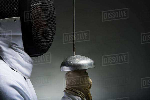 Studio portrait of fencer holding fencing foil - Royalty-free Stock ...