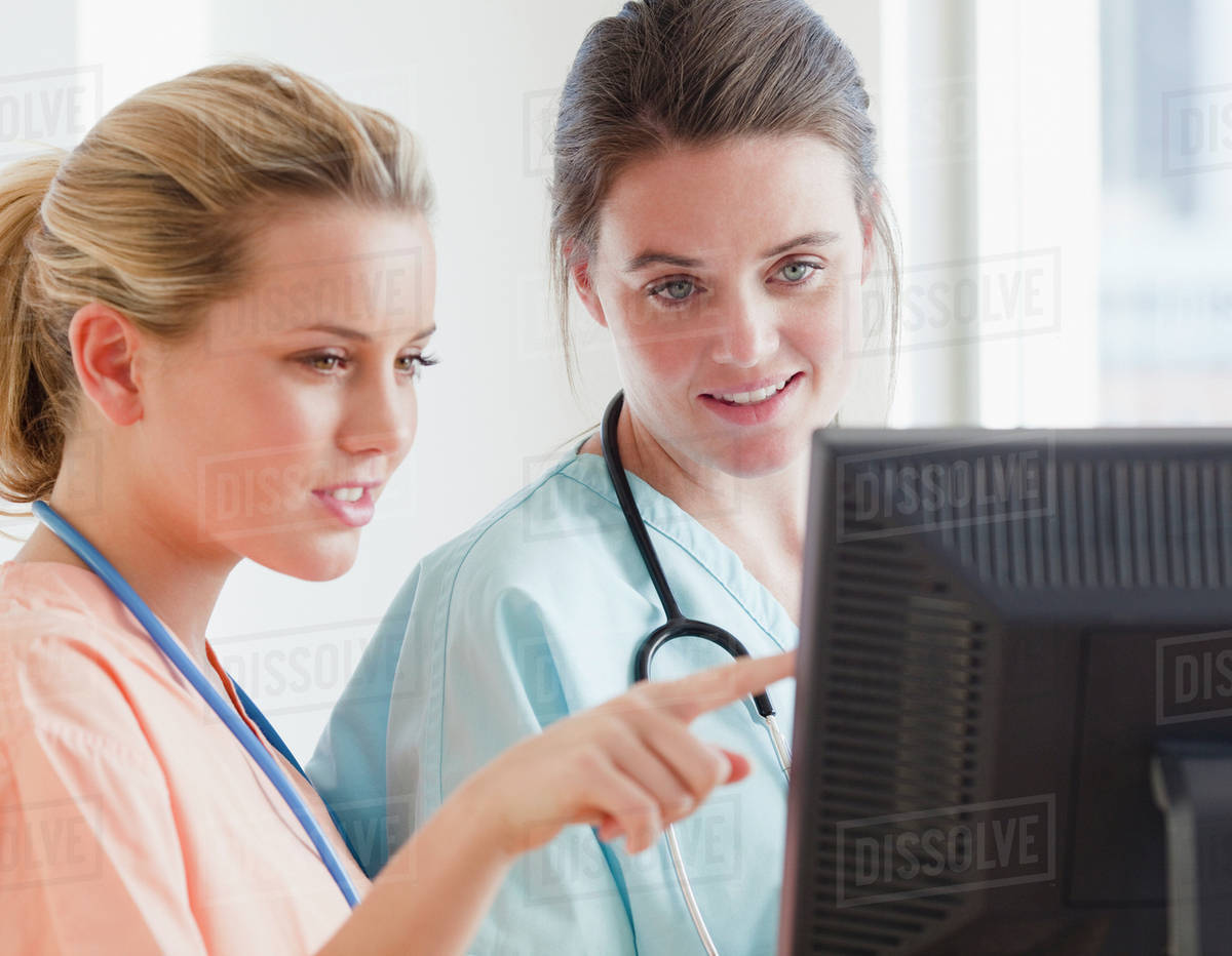 Nurses looking at computer - Royalty-free Stock Photo | Dissolve
