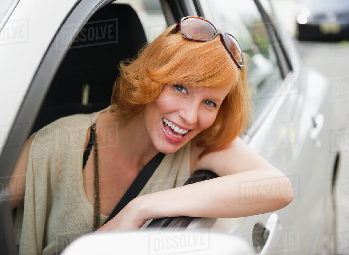 Portrait of young woman driving car - Royalty-free Stock Photo | Dissolve