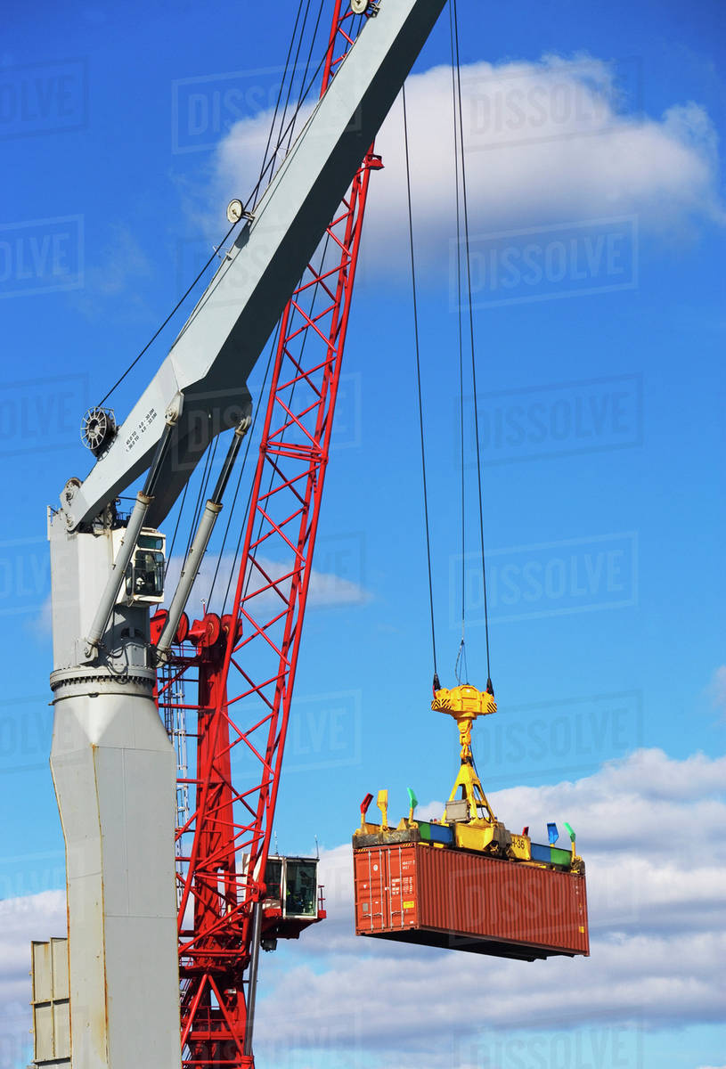 Crane lifting shipping container - Royalty-free Stock Photo | Dissolve