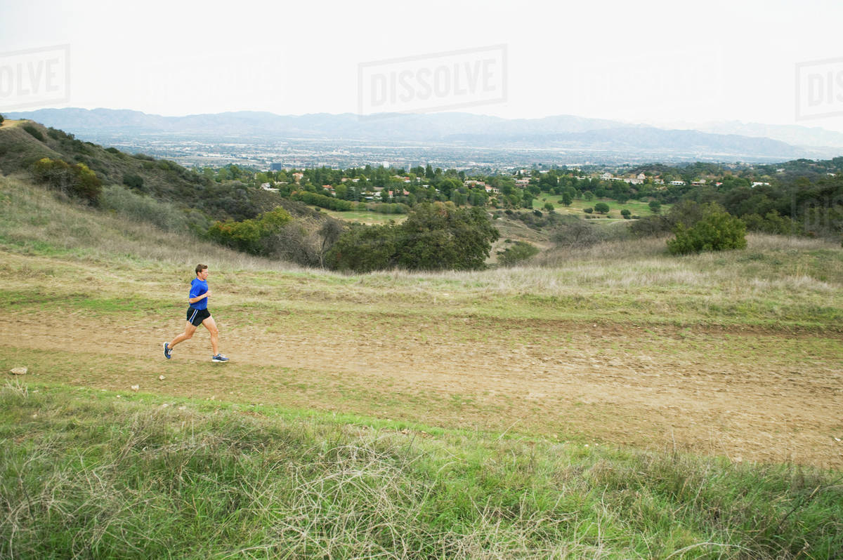 Person running on trail - Stock Photo - Dissolve