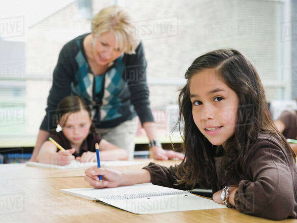 Elementary students writing in their notebooks - Stock Photo - Dissolve