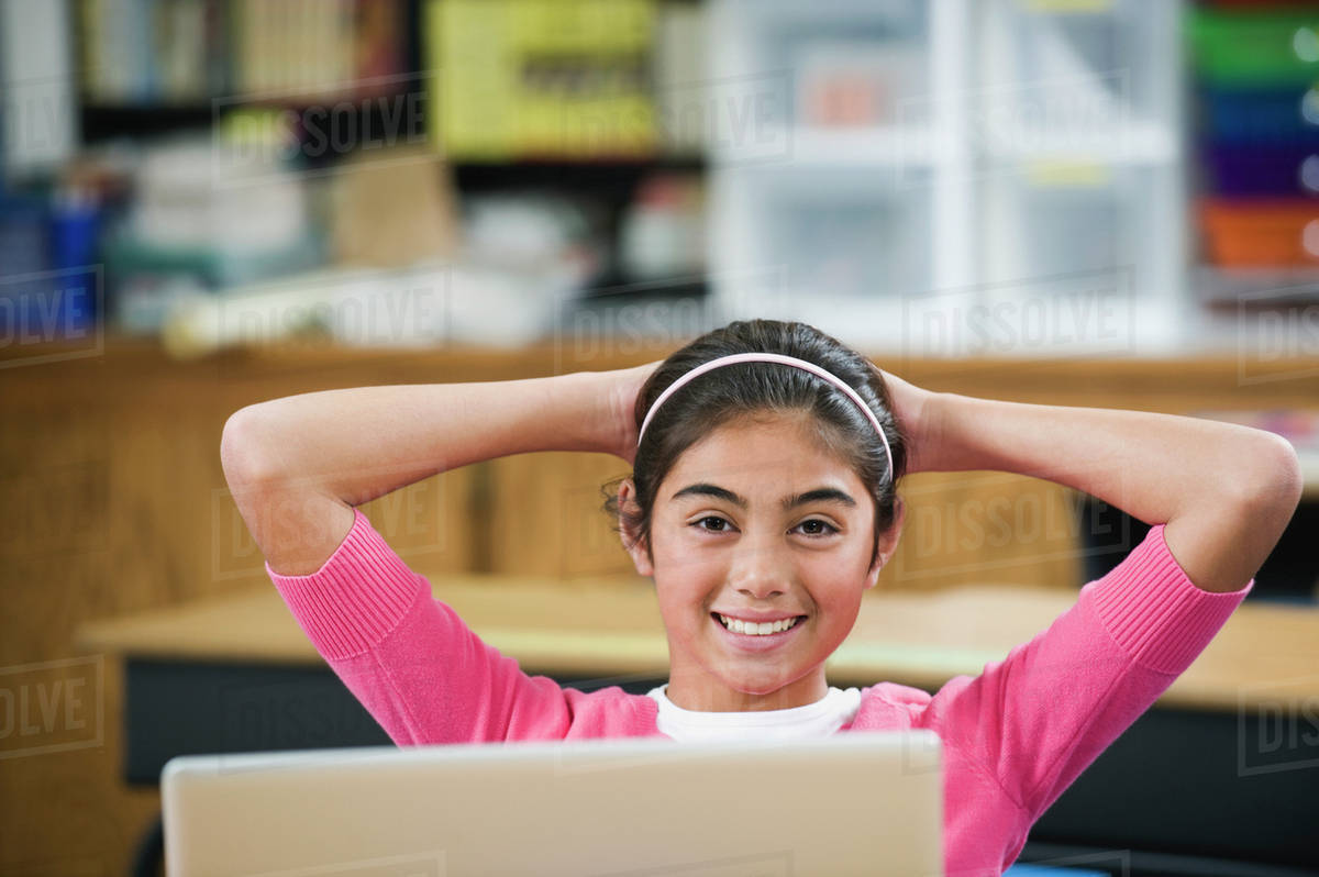 Elementary student relaxing at her desk - Royalty-free Stock Photo ...