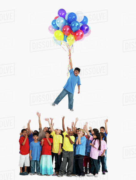 Boy floating away with balloons - Royalty-free Stock Photo | Dissolve