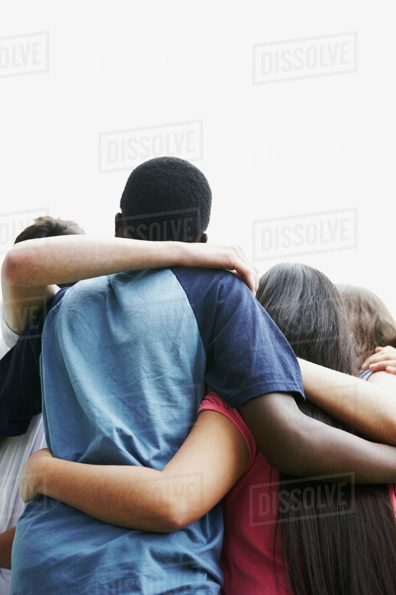 Friends huddled together - Stock Photo - Dissolve