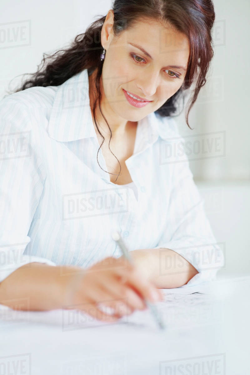 Woman looking at blueprints - Royalty-free Stock Photo | Dissolve