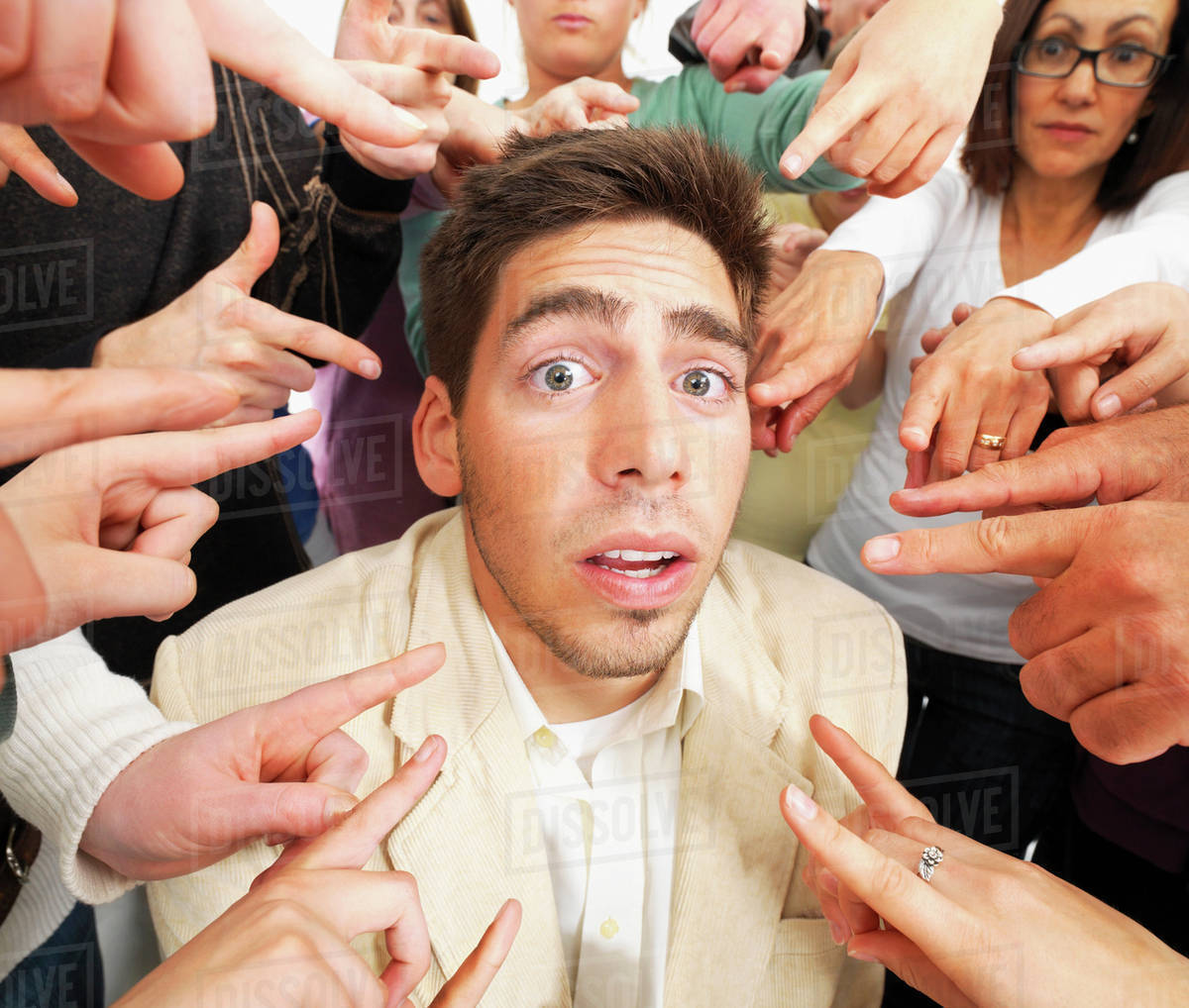 Group of people pointing at one person - Stock Photo - Dissolve