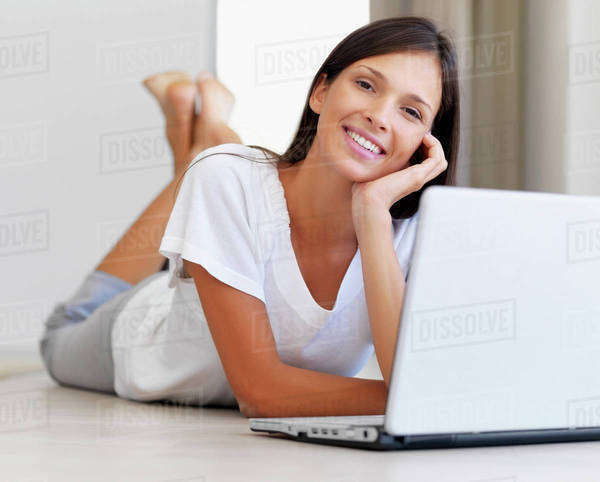 Woman looking at laptop - Royalty-free Stock Photo | Dissolve