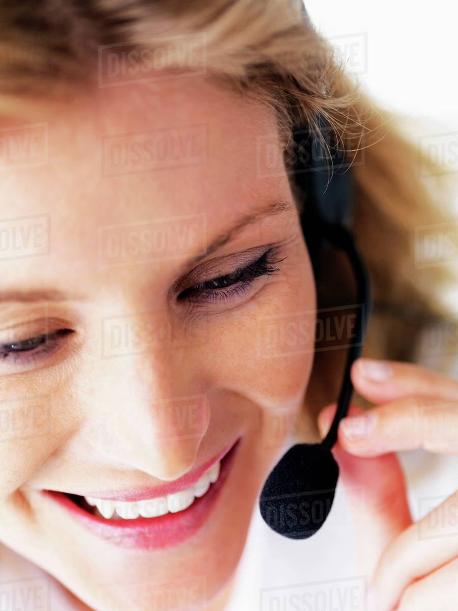 Receptionist wearing headset - Royalty-free Stock Photo | Dissolve