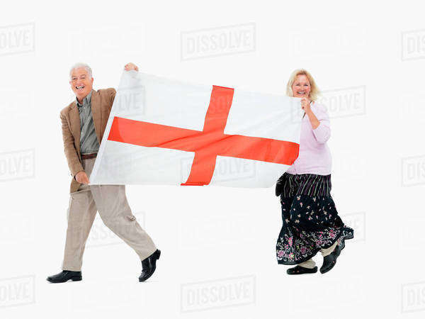 Two people carrying the flag of England - Stock Photo - Dissolve