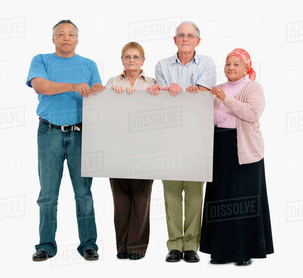 Four people holding a blank poster - Royalty-free Stock Photo | Dissolve