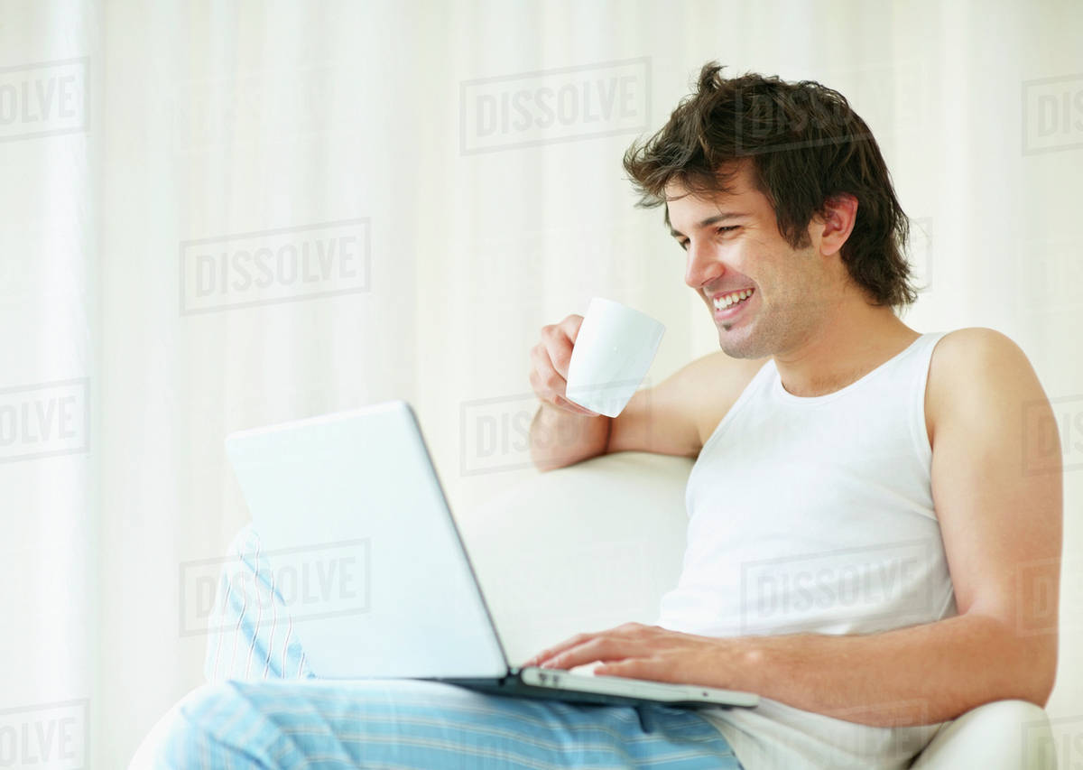 Relaxed man browsing the internet - Stock Photo - Dissolve
