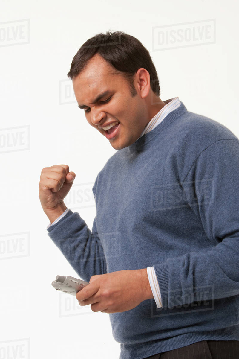 Excited man reading text message - Stock Photo - Dissolve