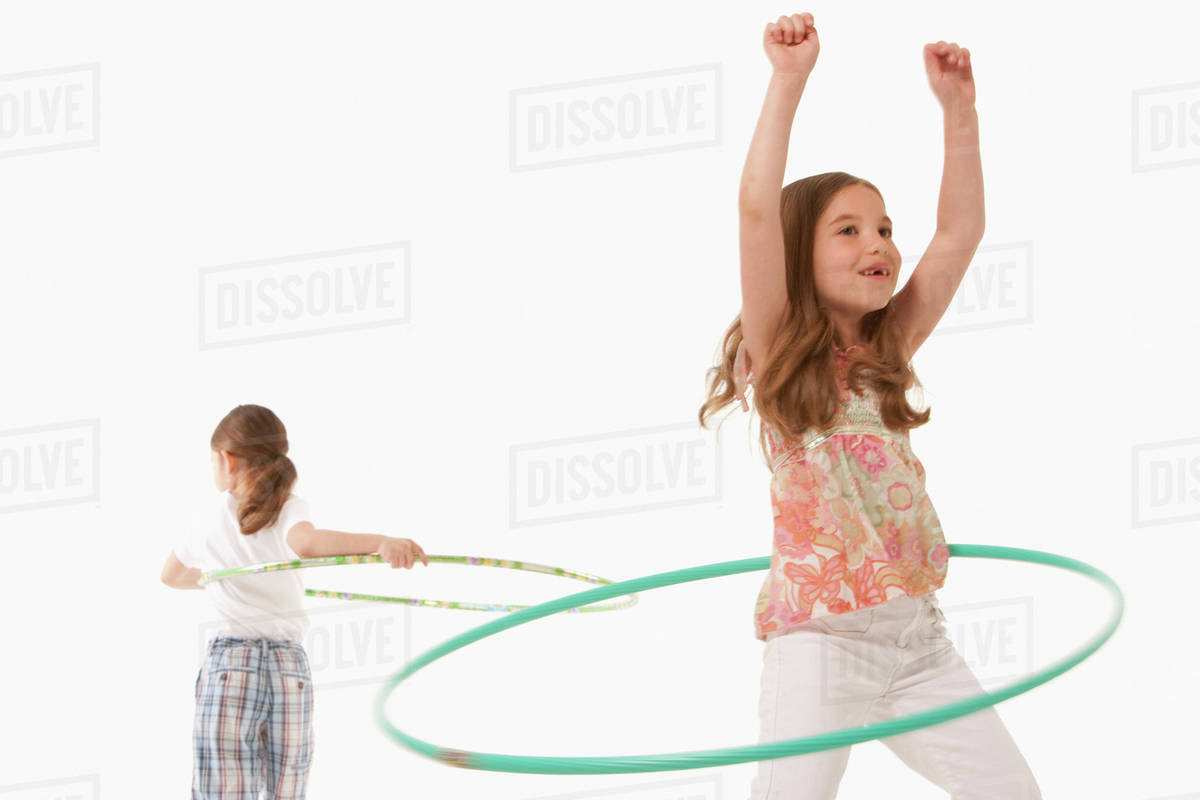 Children playing with hula hoops - Royalty-free Stock Photo | Dissolve