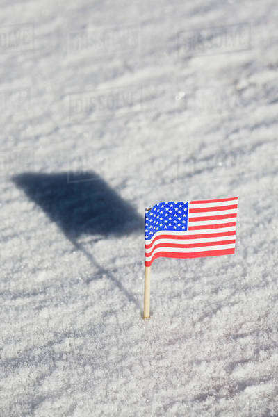 American flag in the snow - Stock Photo - Dissolve