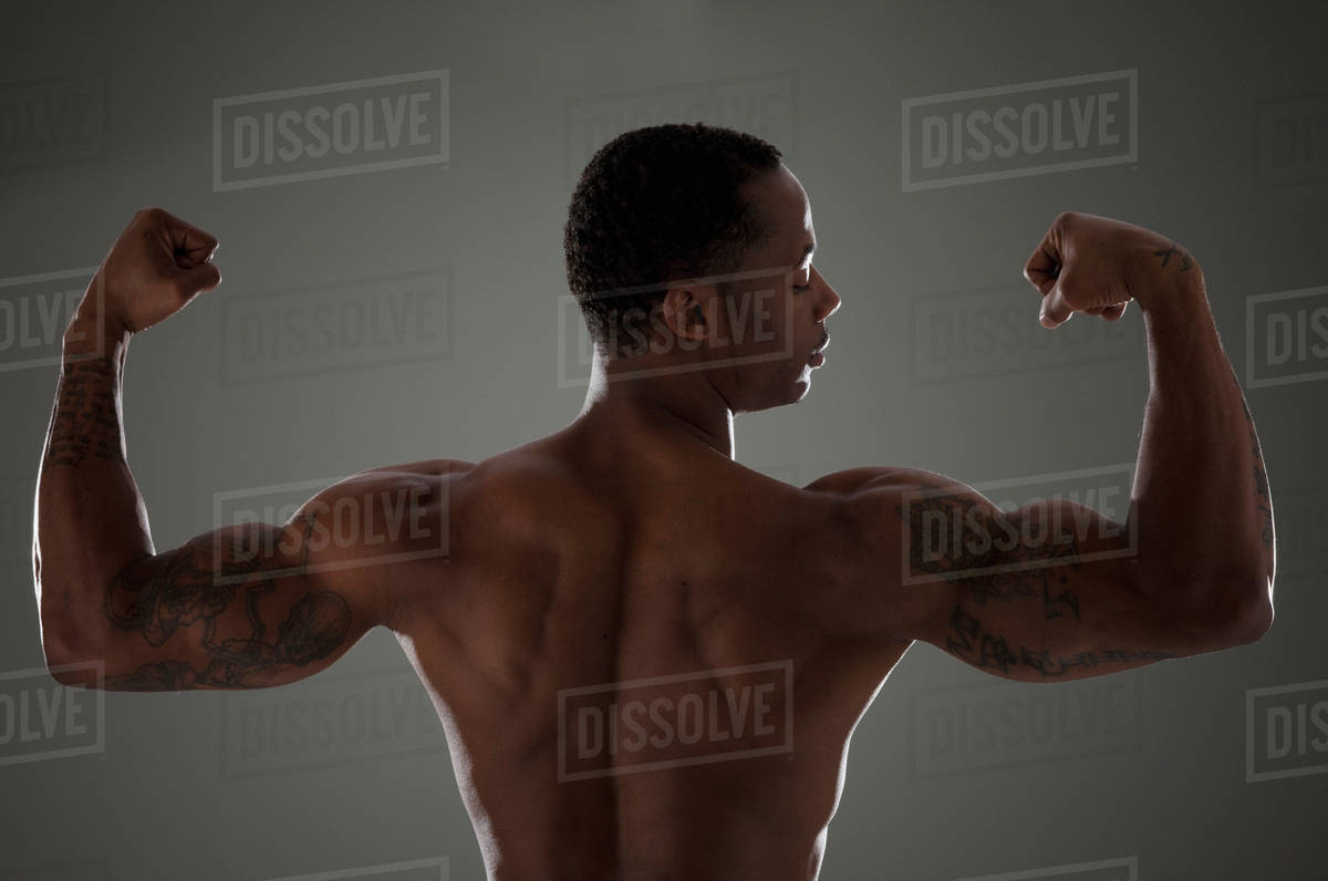 Physically fit man flexing his triceps - Royalty-free Stock Photo ...