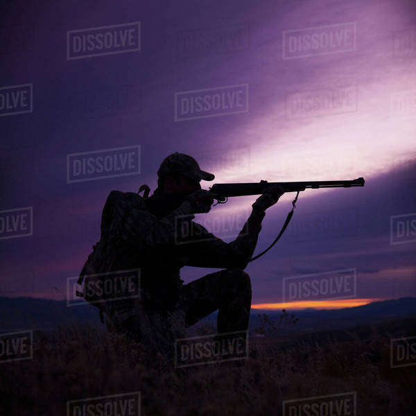 Hunter pointing his rifle - Stock Photo - Dissolve