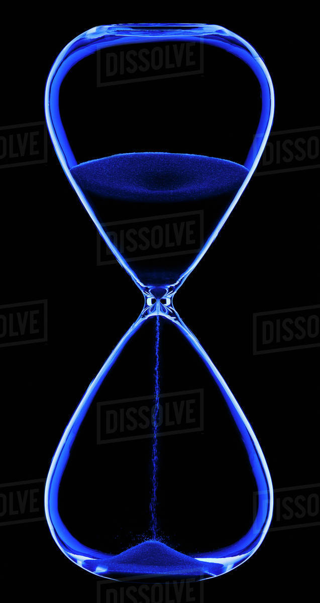 Studio shot of hour-glass on black background - Stock Photo - Dissolve