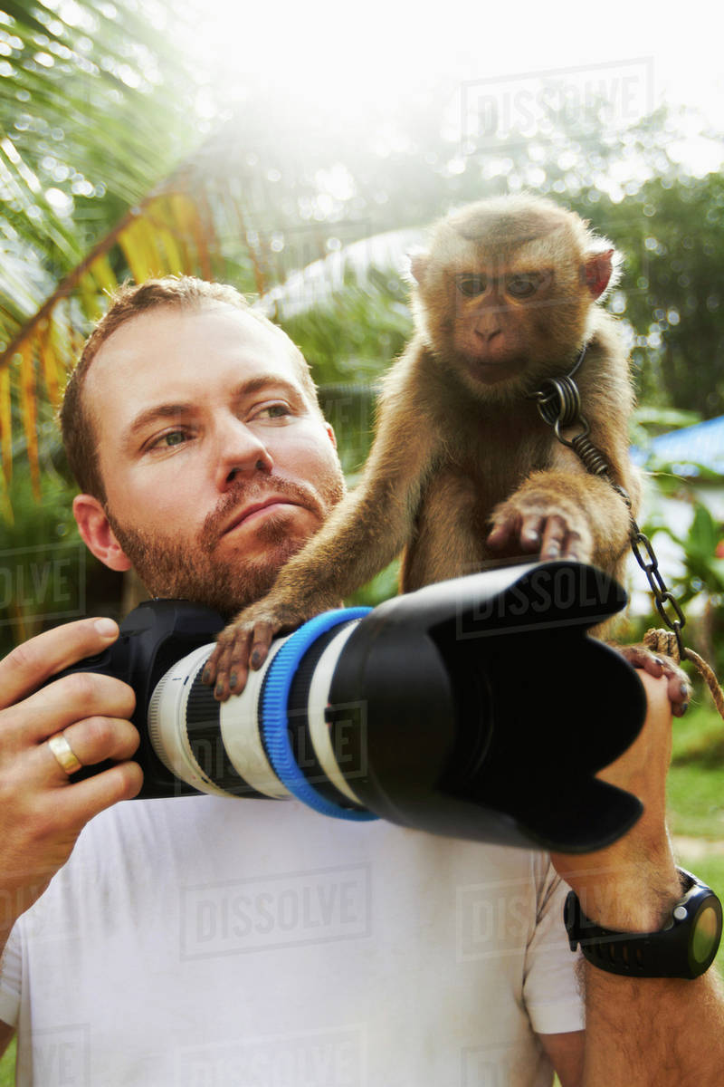 Portrait of man with camera and macaque monkey - Royalty-free Stock ...