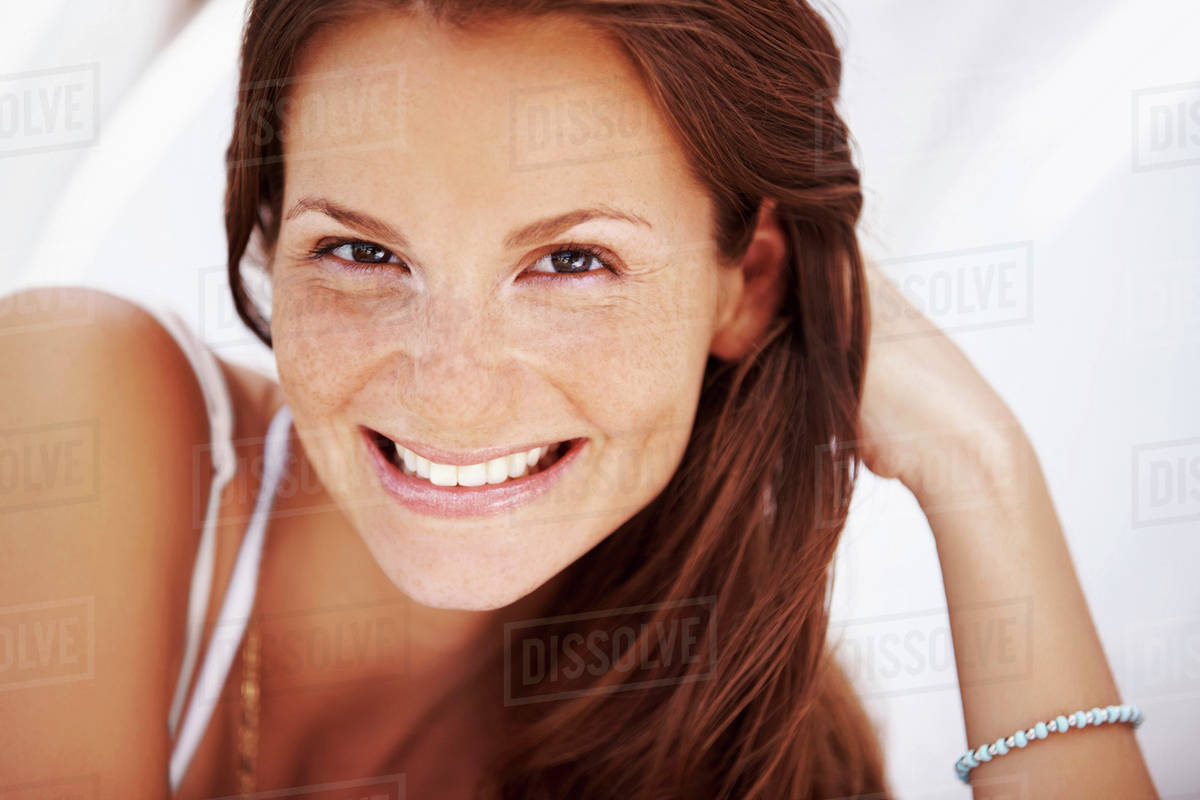 Studio portrait of woman smiling - Royalty-free Stock Photo | Dissolve