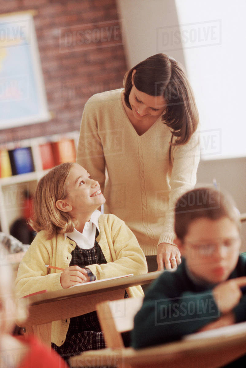 Elementary school student talking to teacher - Royalty-free Stock Photo ...