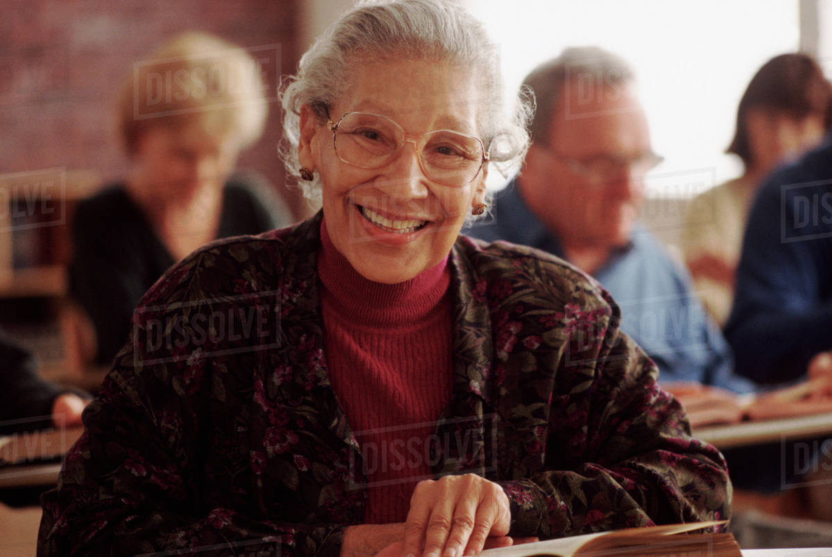 Senior student sitting at desk - Royalty-free Stock Photo | Dissolve
