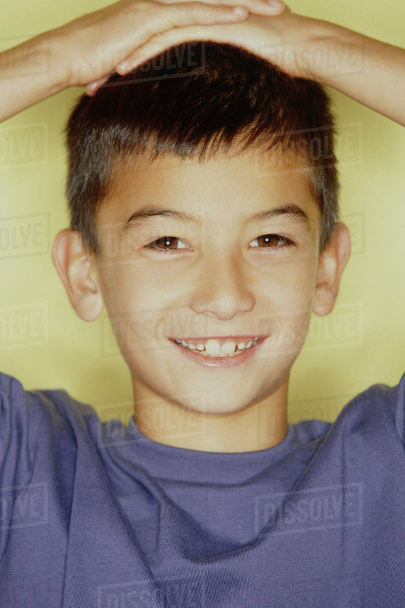 Cute young boy with his hands on his head - Royalty-free Stock Photo ...